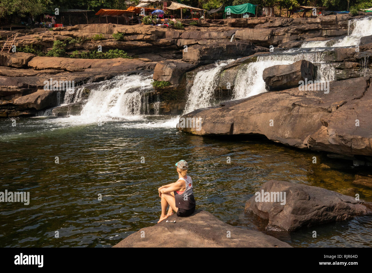 Cambodia, Koh Kong Province, Tatai, Waterfall, western tourist sat on ...