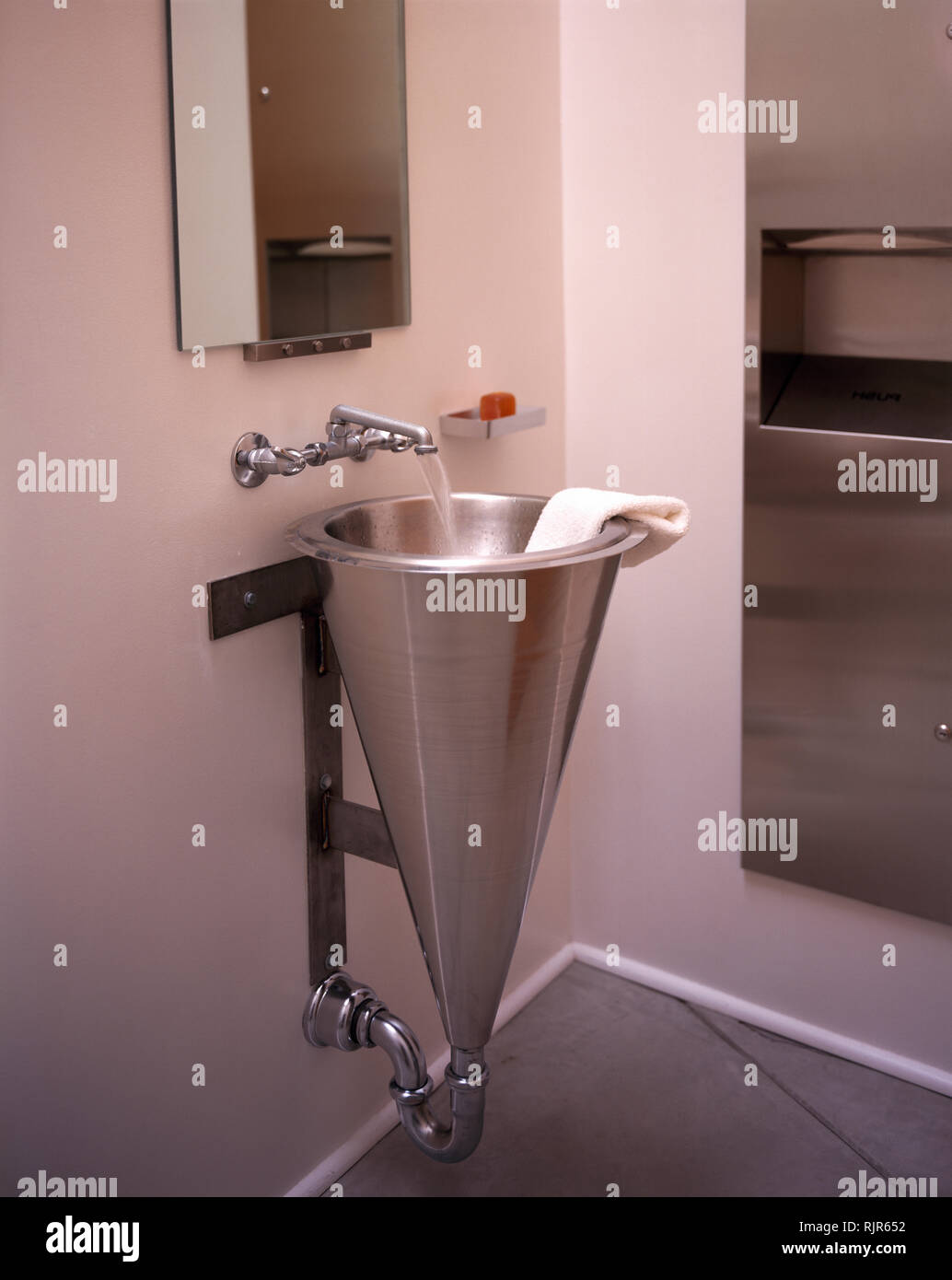 Tap pouring water into conical basin Stock Photo - Alamy