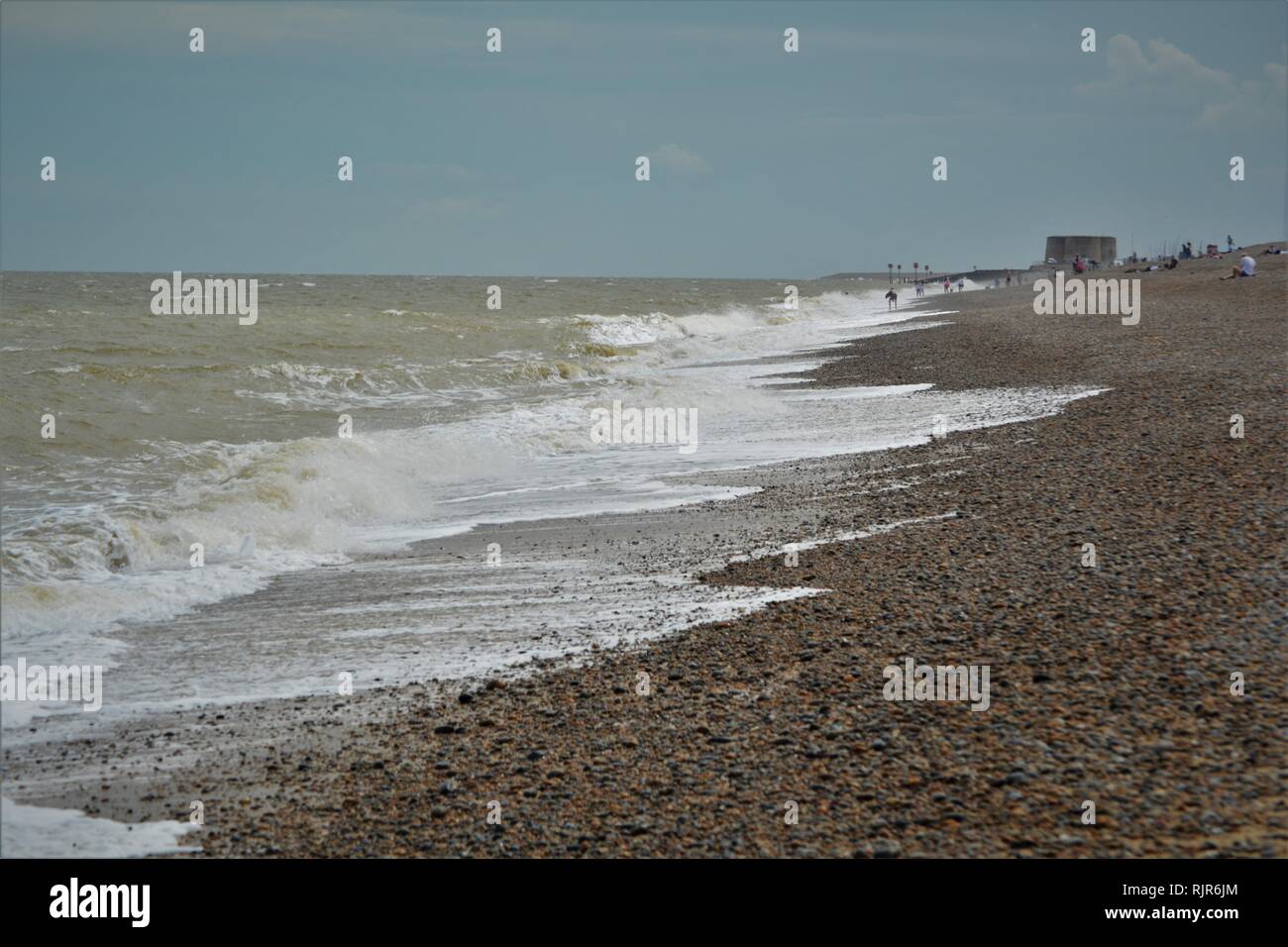 Waves washing on the shore of the shingle beach in England Stock Photo ...