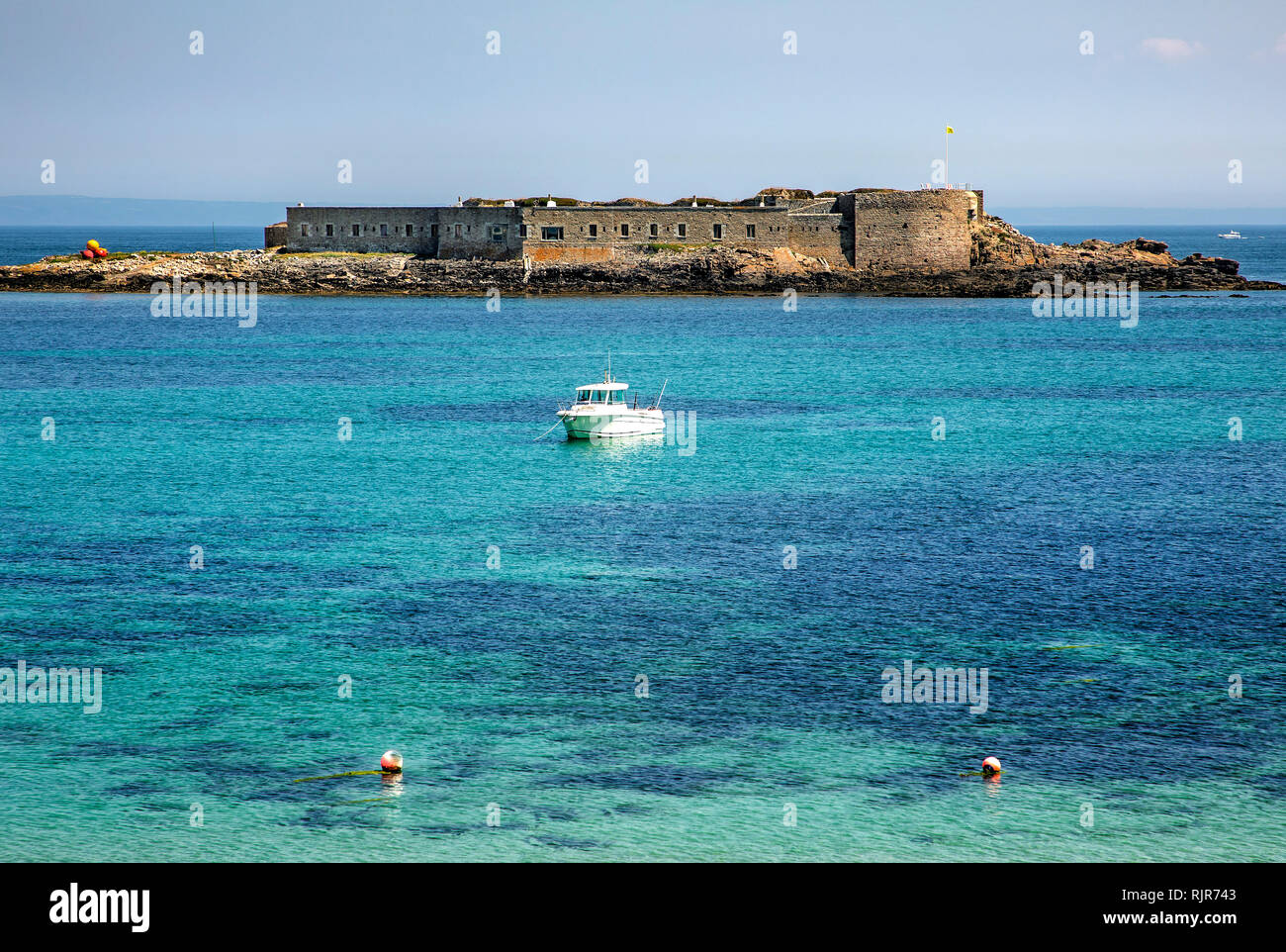 View over Longis Bay Alderney, showing the island fort of Ile de Raz ...