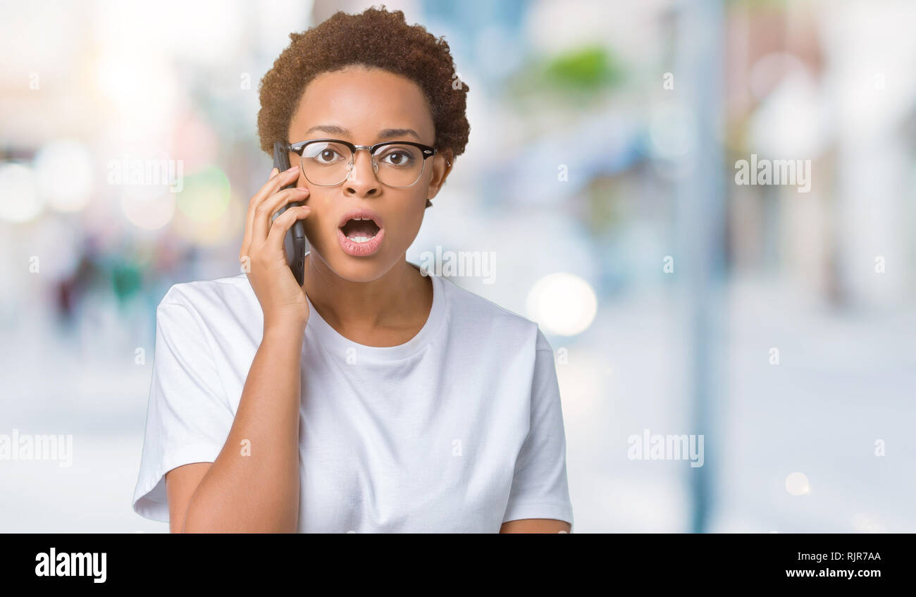 Young african american woman talking on the phone over isolated ...