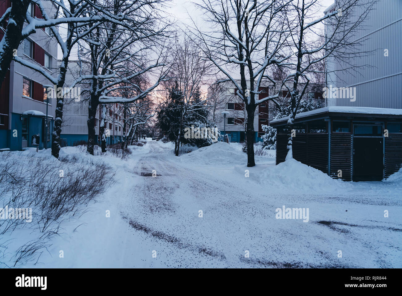 Walking though the suburbs with concrete panel houses on a cold winter ...