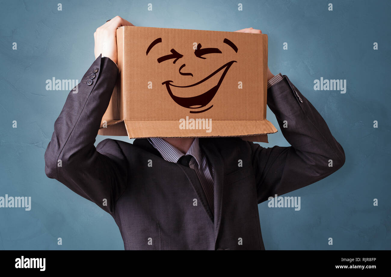 Young boy standing and gesturing with a cardboard box on his head Stock ...