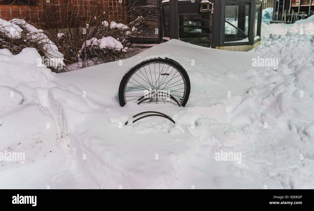 Lonely abandoned bike wheel in the snow outdoor Stock Photo - Alamy