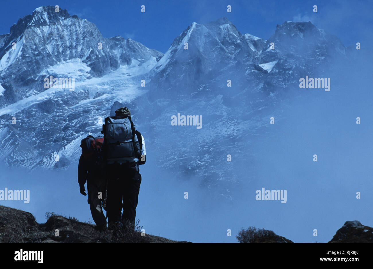 Caption: Kanchendzonga, Sikkim, India - Mar 2003. Trekkers on the five ...