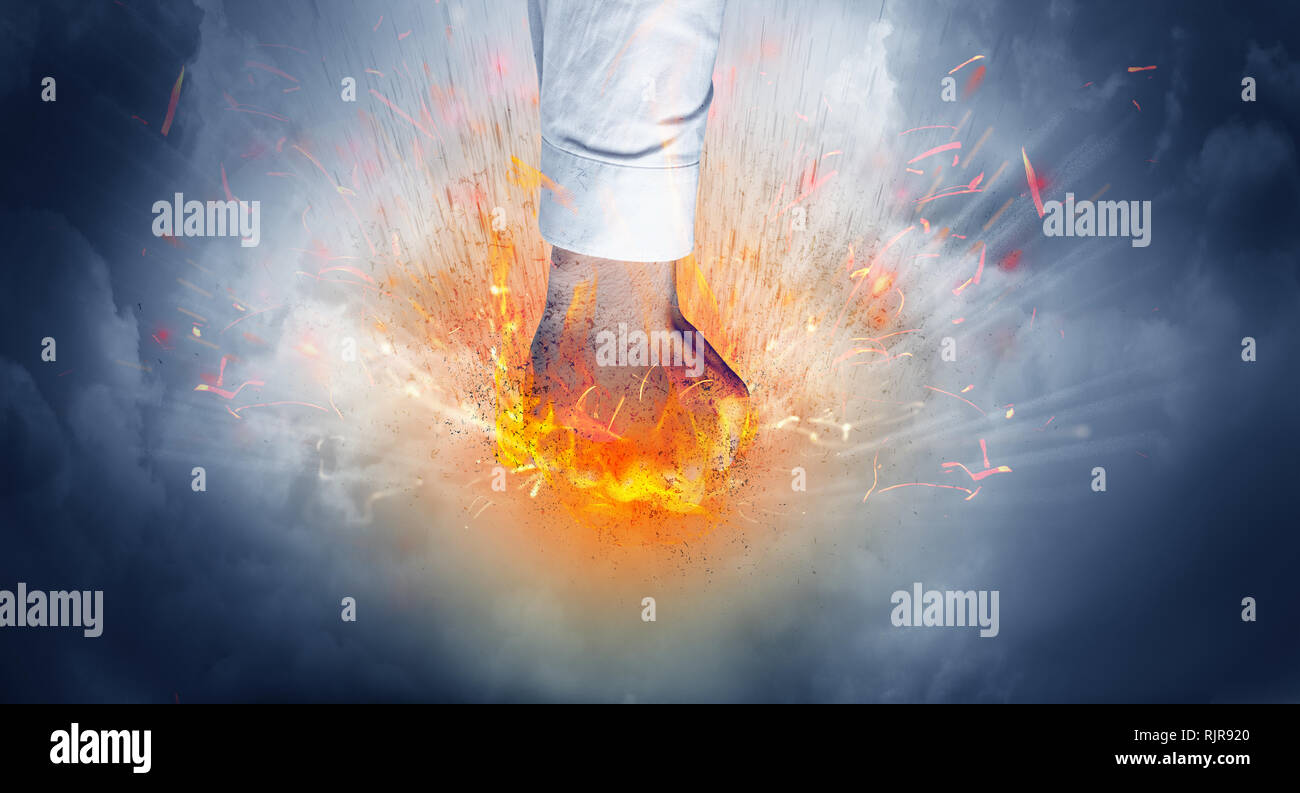 Hand hits strongly and makes fire beam around Stock Photo - Alamy