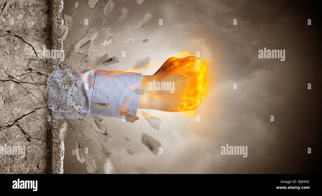 Big hand hits intense and breaks a crass stonewall Stock Photo - Alamy