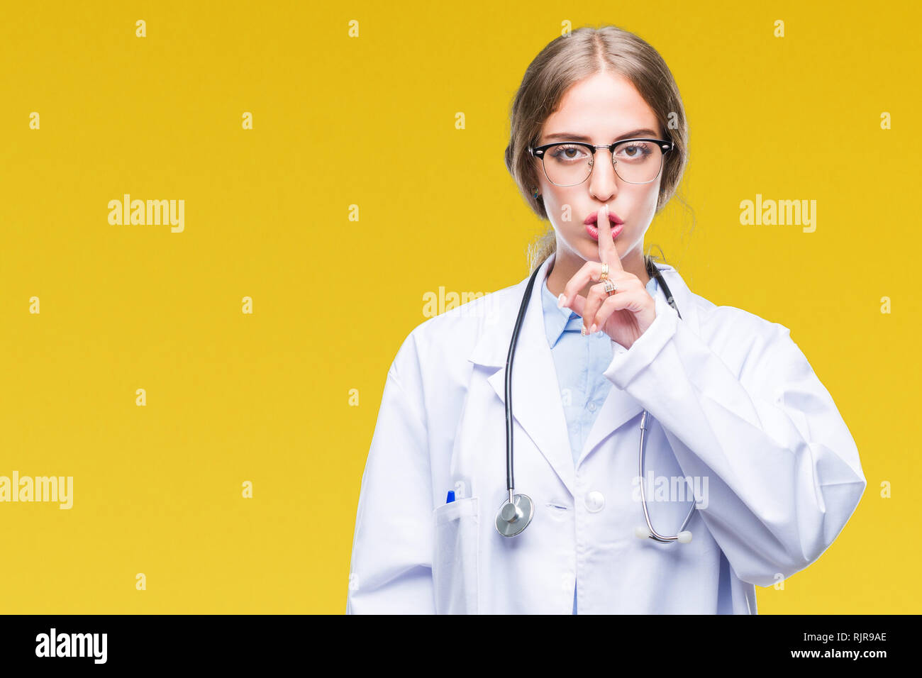 Beautiful young blonde doctor woman wearing medical uniform over ...
