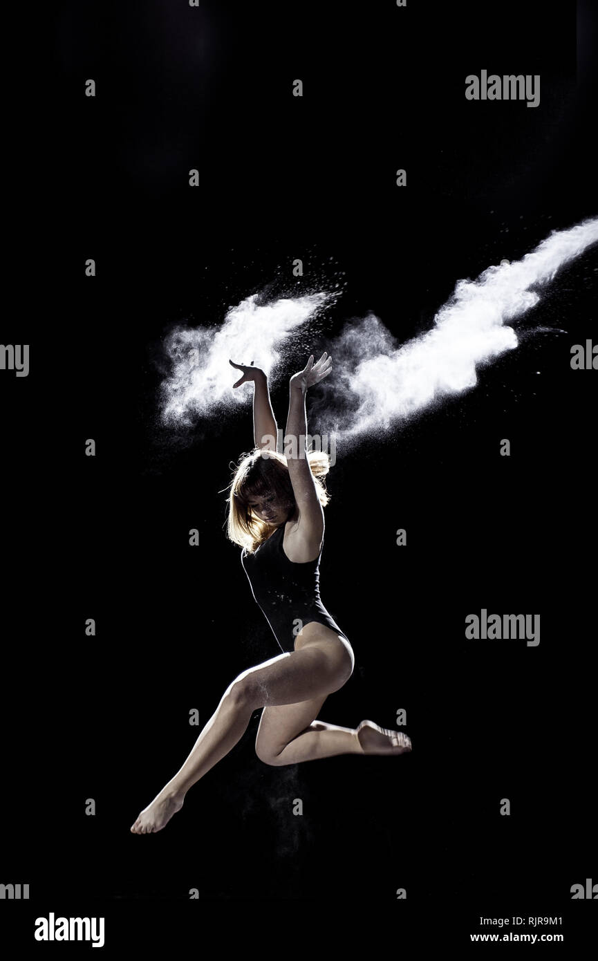 Girl dancing with a flour on the black background on the sceene Stock ...