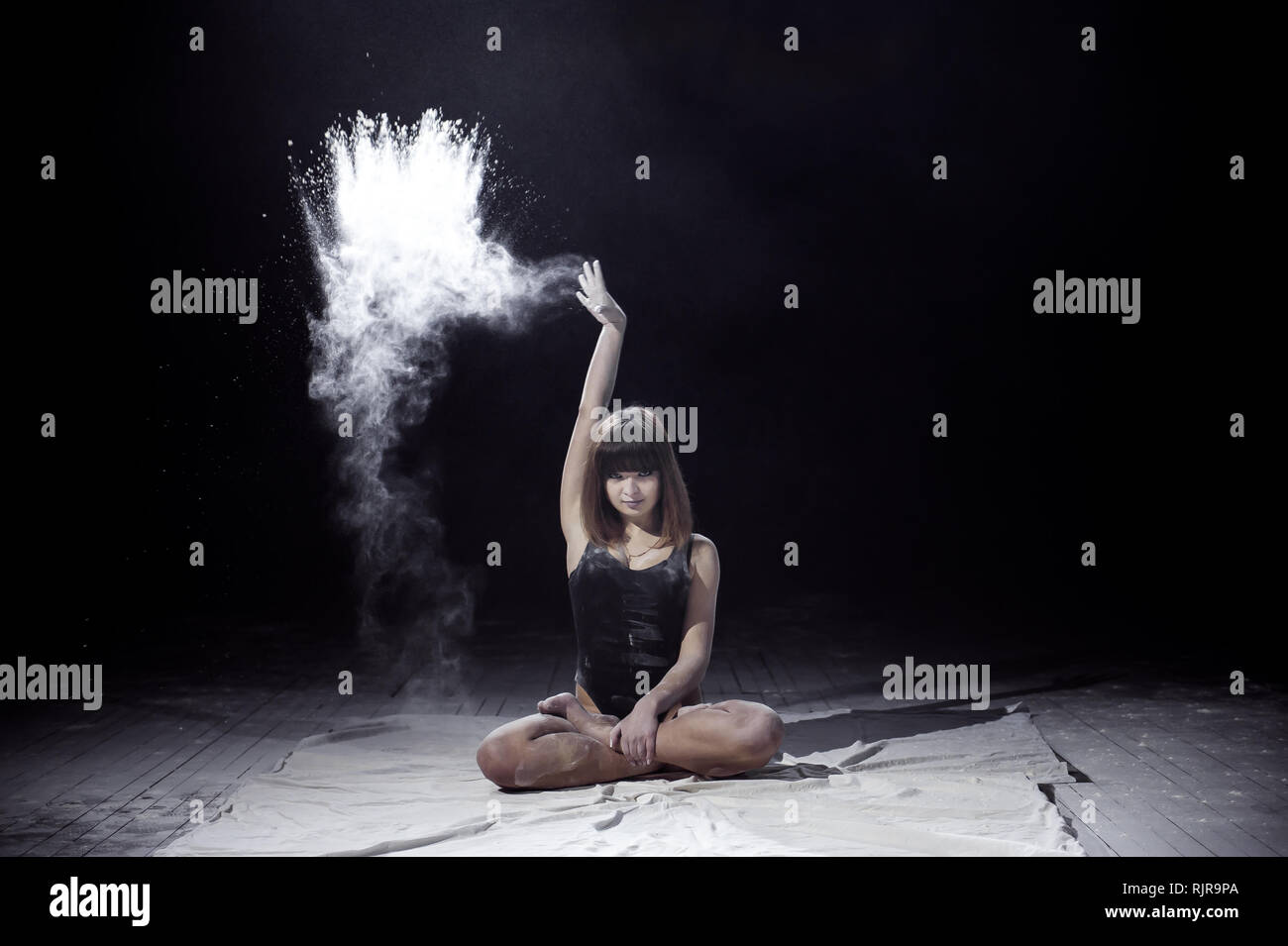 Girl dancing with a flour on the black background on the sceene Stock ...