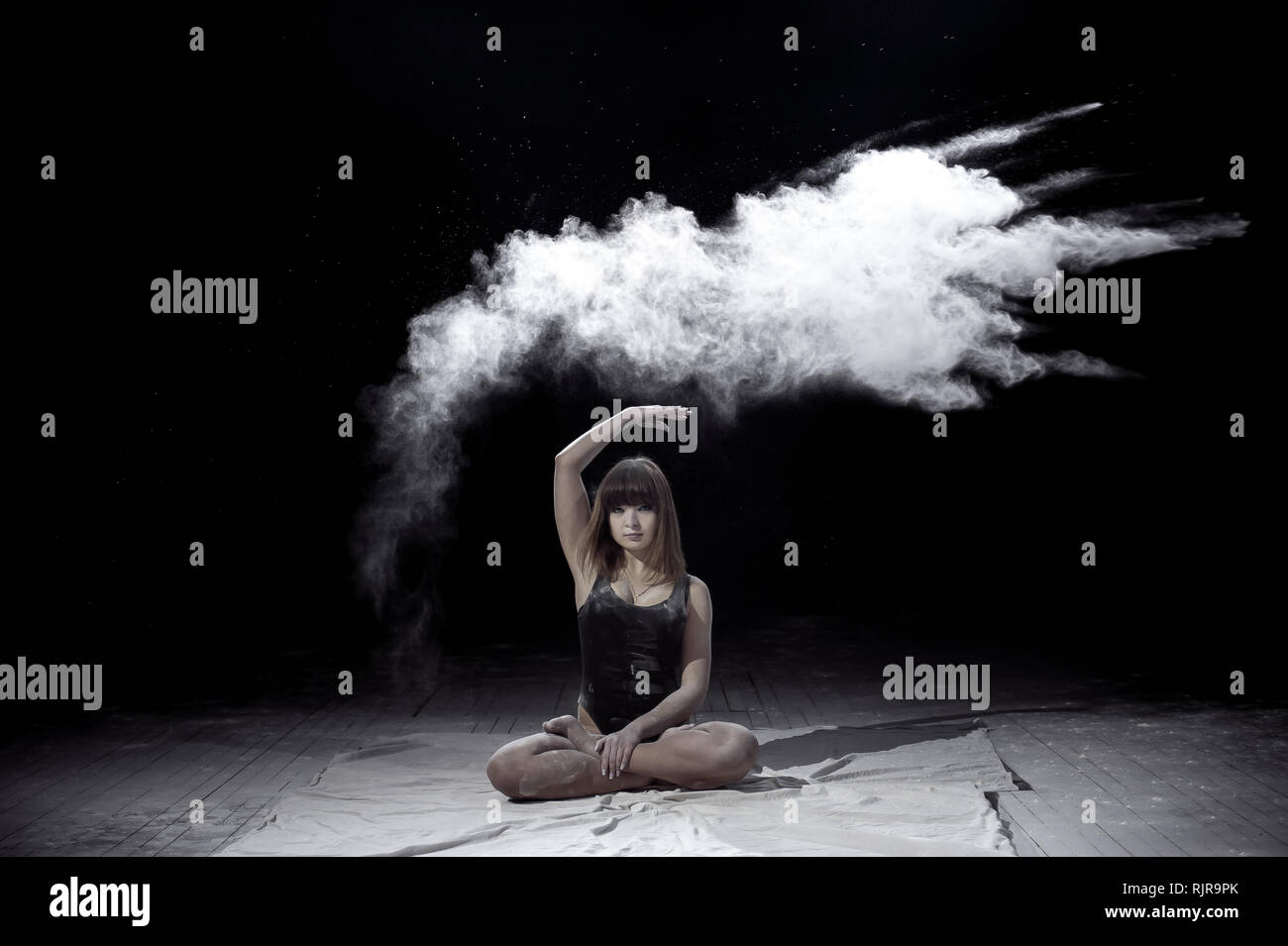 Girl dancing with a flour on the black background on the sceene Stock ...