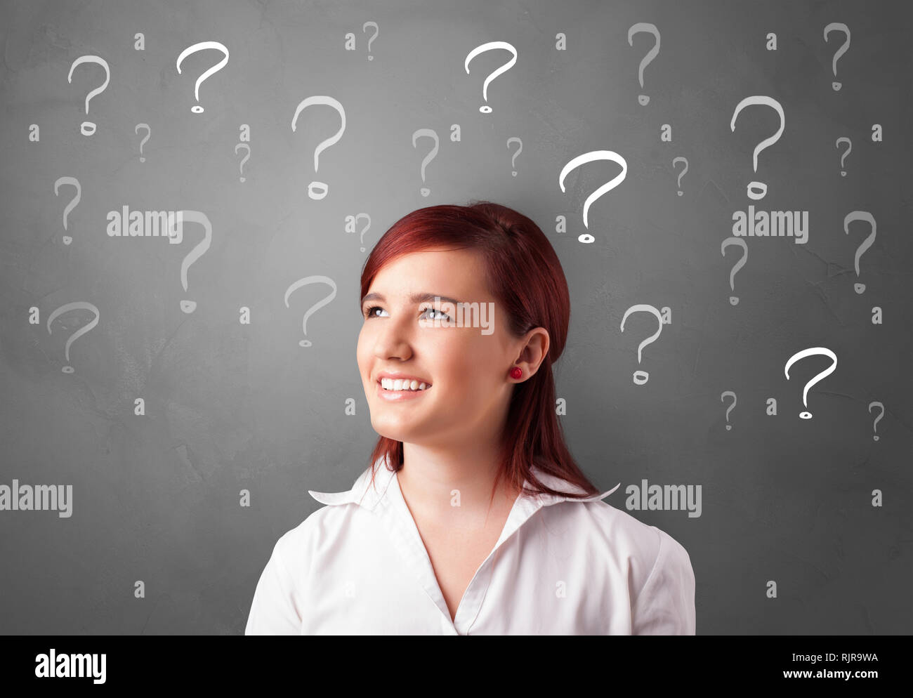 Person with question marks around face Stock Photo - Alamy