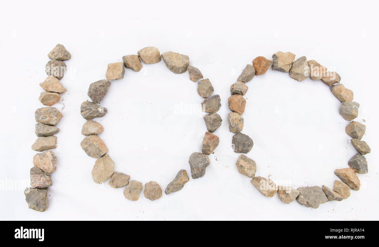 The number 100 spelled out in an illustration using stones and rocks ...