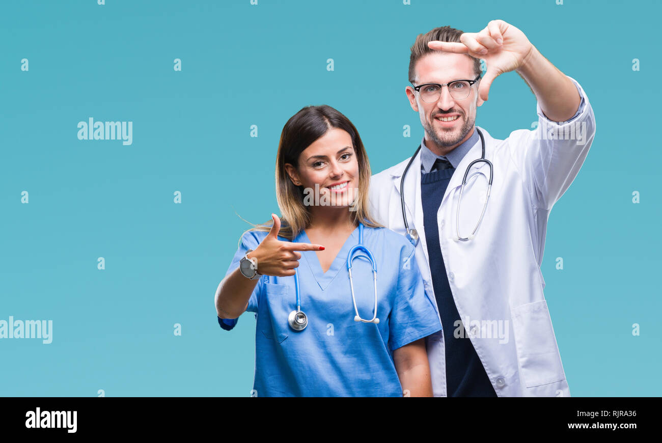 Young couple of doctor and surgeon over isolated background smiling ...