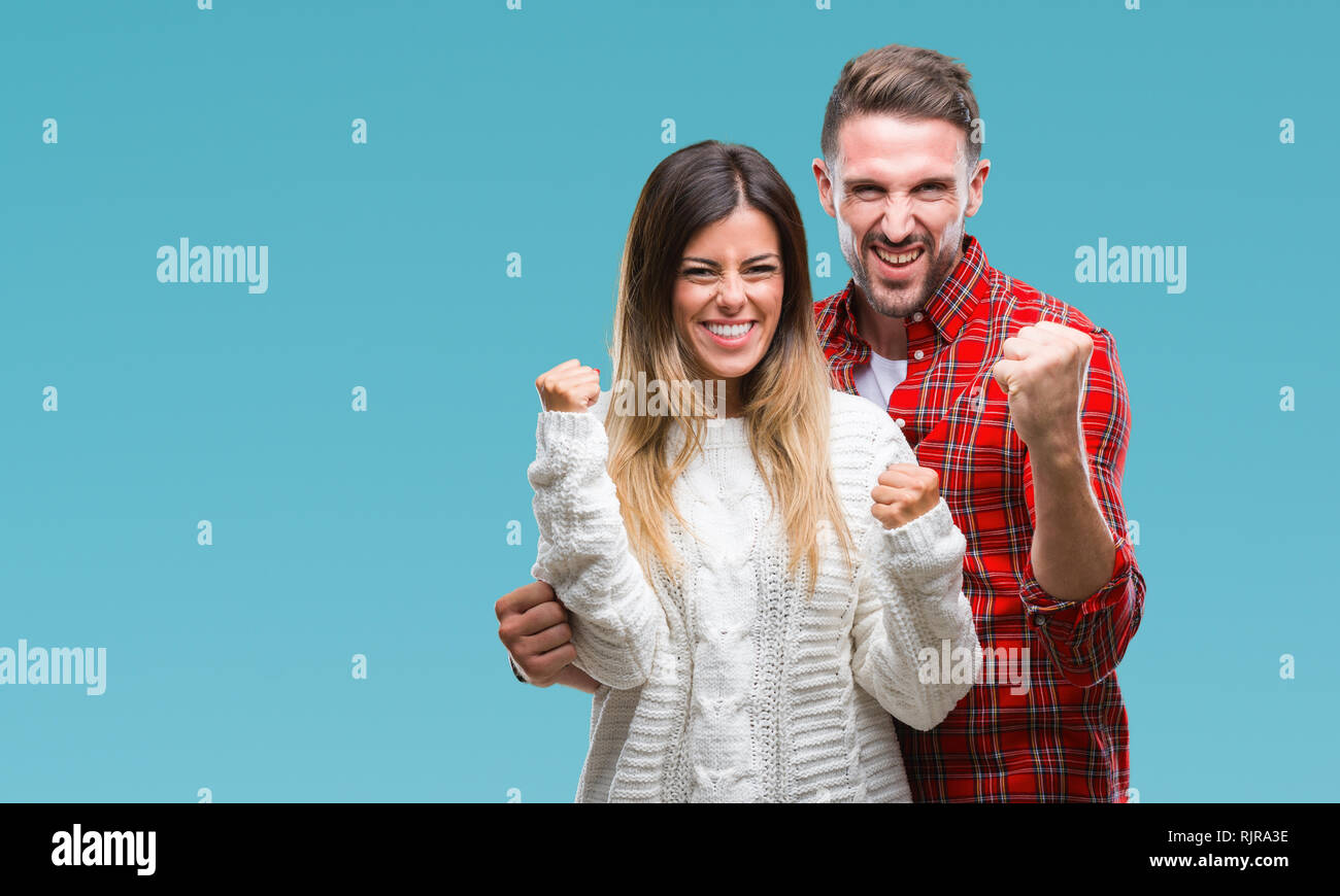 Young couple in love wearing winter sweater over isolated background ...