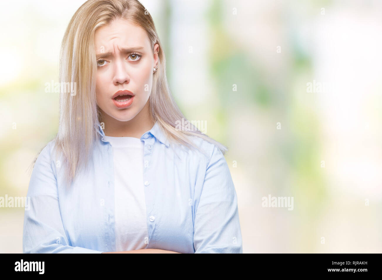 Young blonde woman over isolated background skeptic and nervous ...