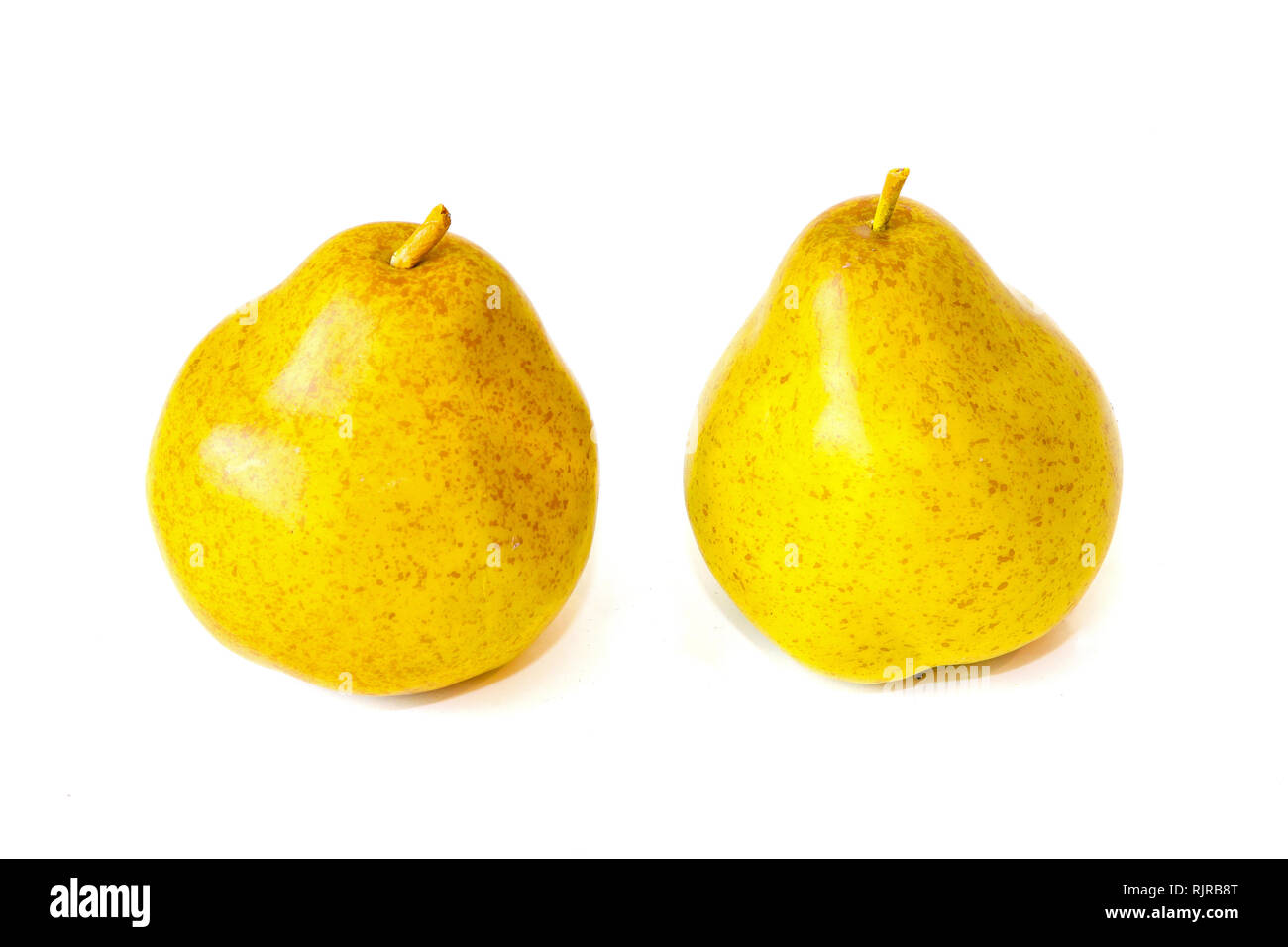 Two organic yellow pears on white background Stock Photo - Alamy