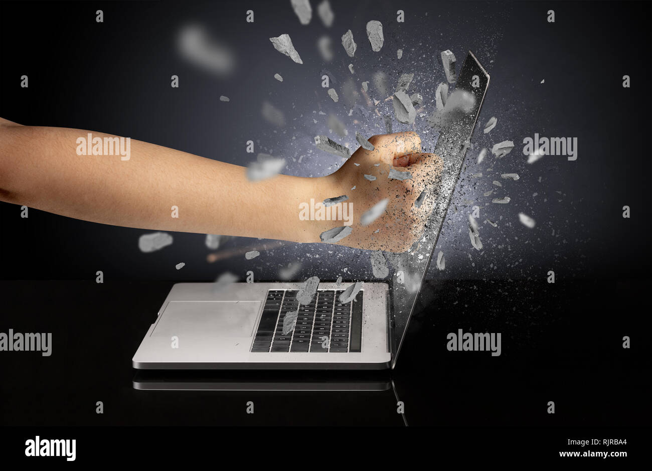 Strong male hand breaks laptop screen Stock Photo - Alamy