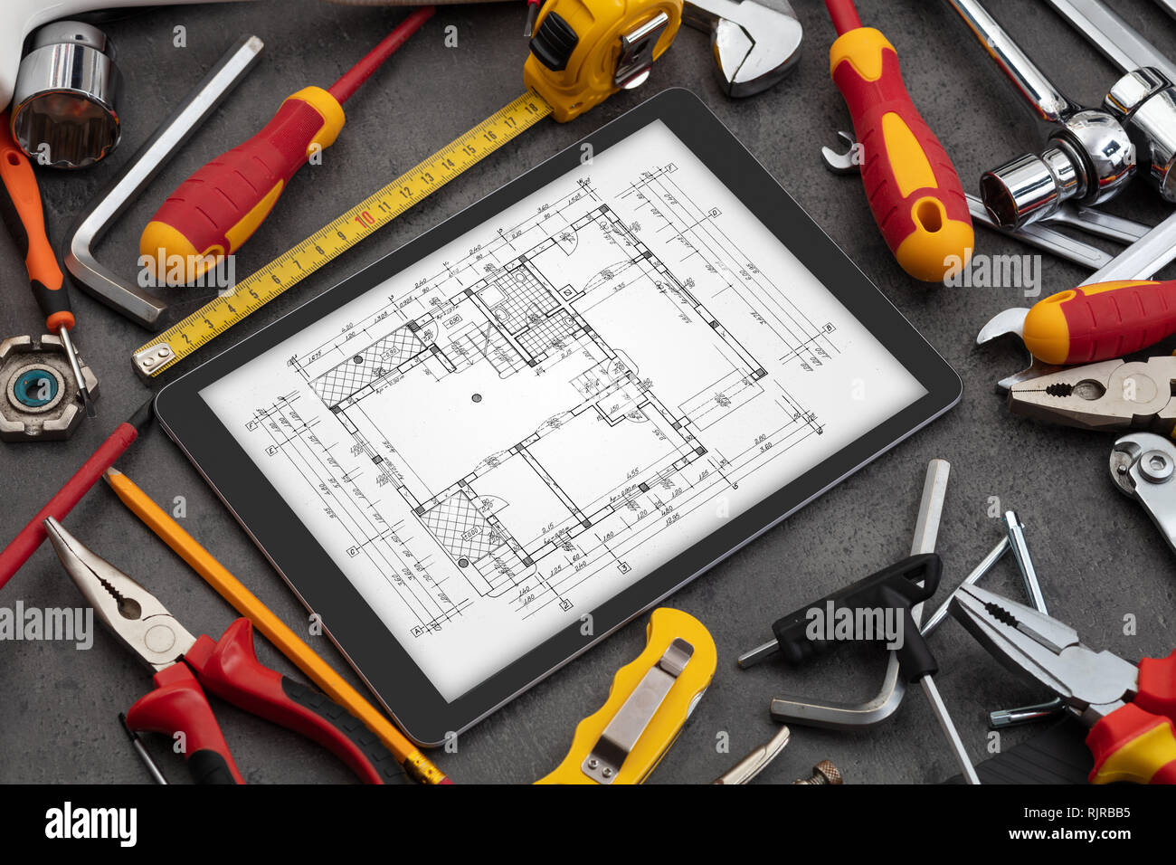Tablet with construction tools and blueprint concept Stock Photo - Alamy