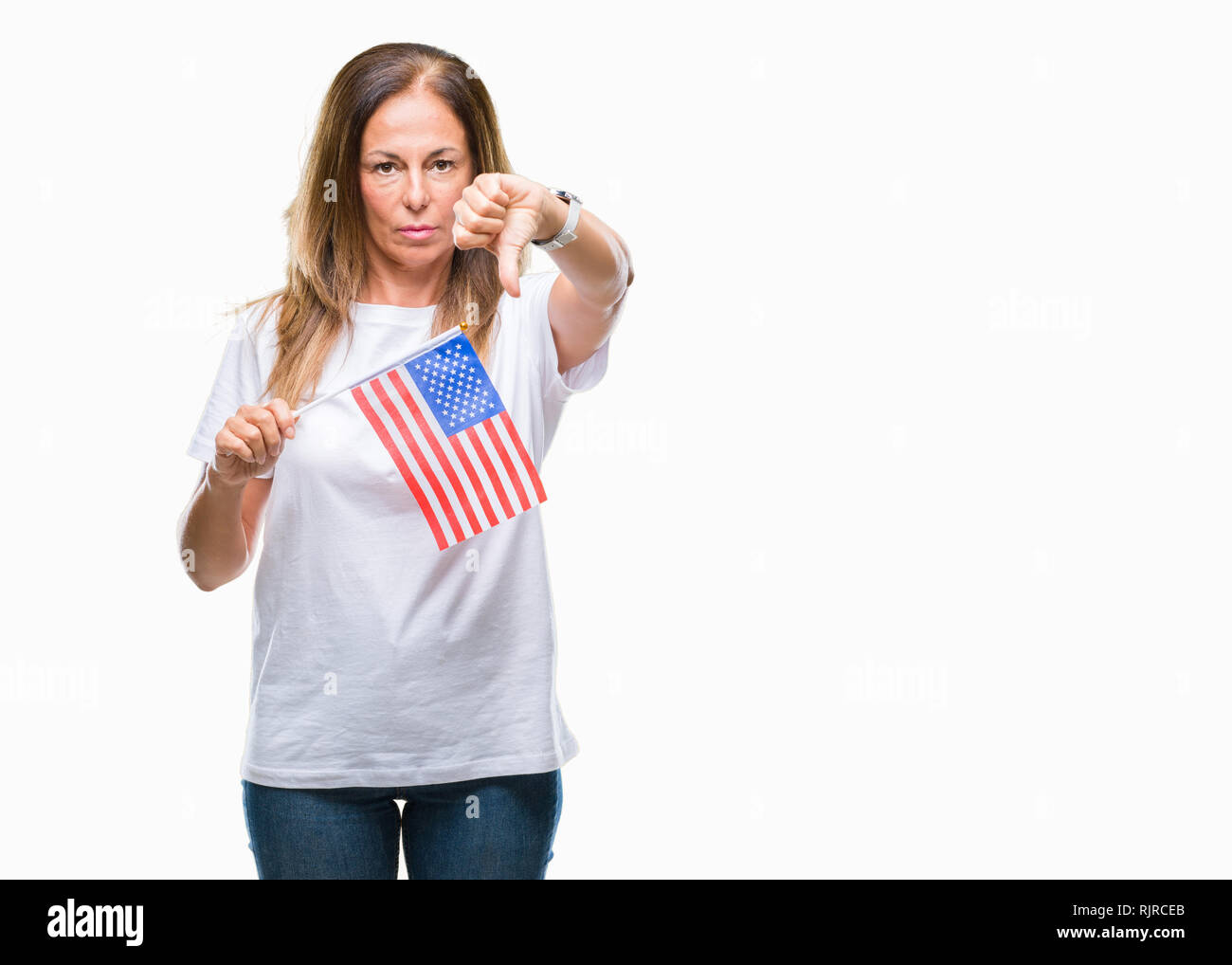 Middle age hispanic woman holding flag of United States of America over ...