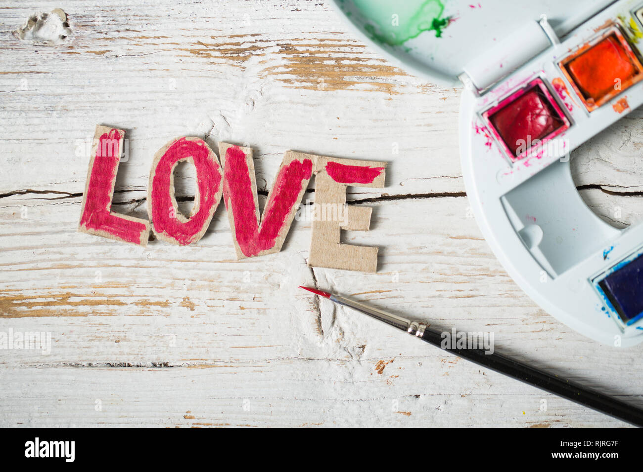 Love symbols hand painted in watercolor on white wooden table Stock ...