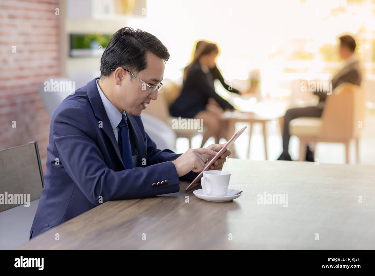 Portrait of Businessman working in cafe using smart phone tablet with ...