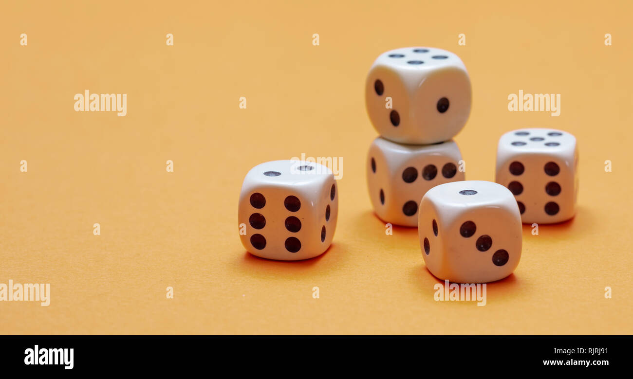 Dice on orange color background, copy space, front view Stock Photo - Alamy