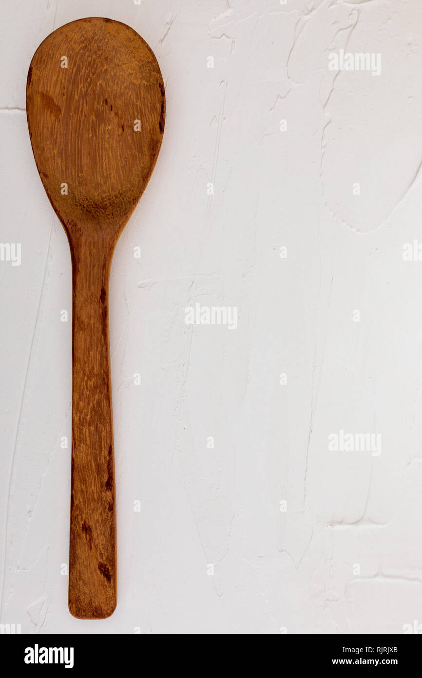 Wooden spoon on white background with texture. Space to insert your ...