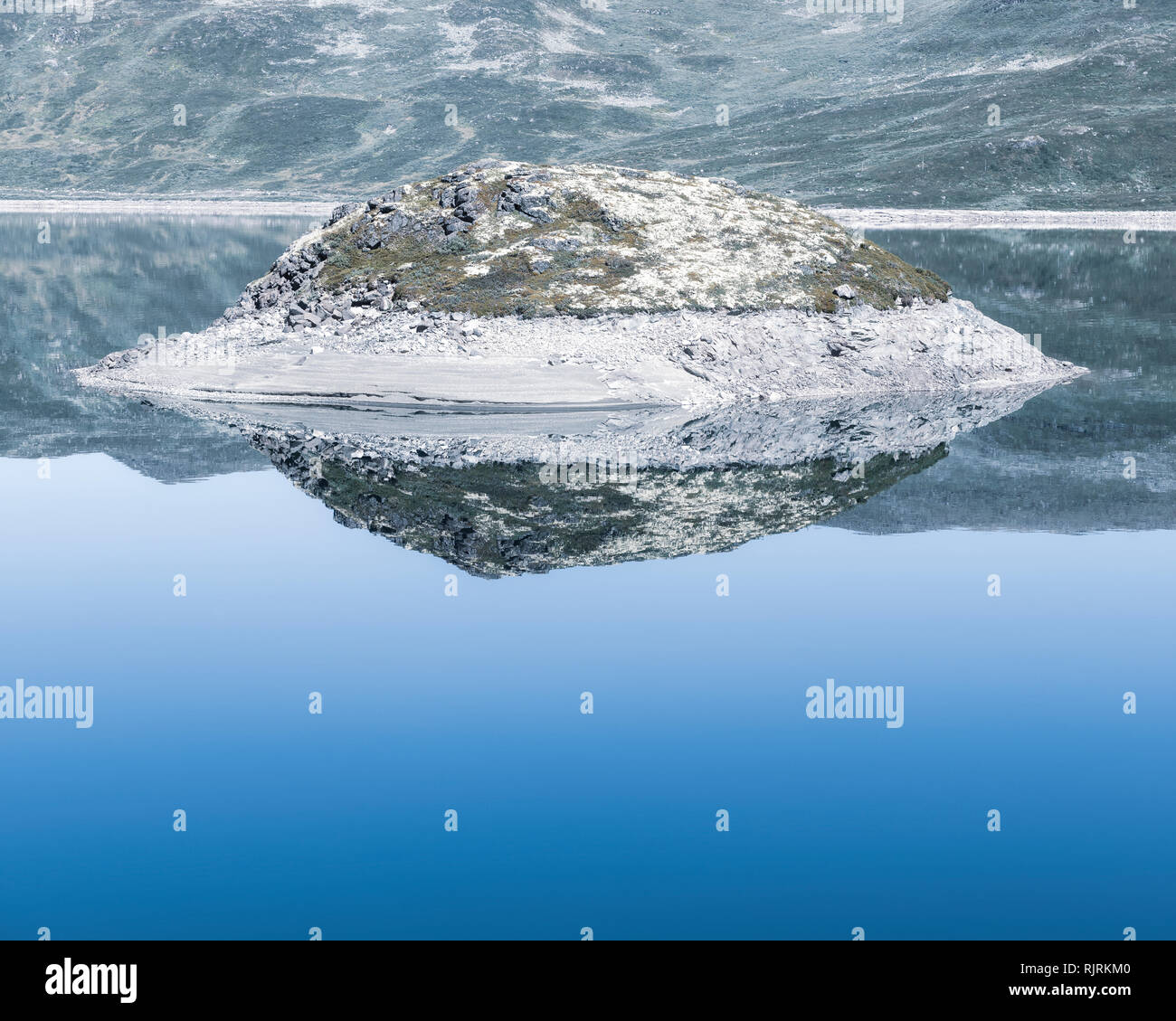 Island in Lake Tyin surrounded by Jutunheimen mountains, close up ...