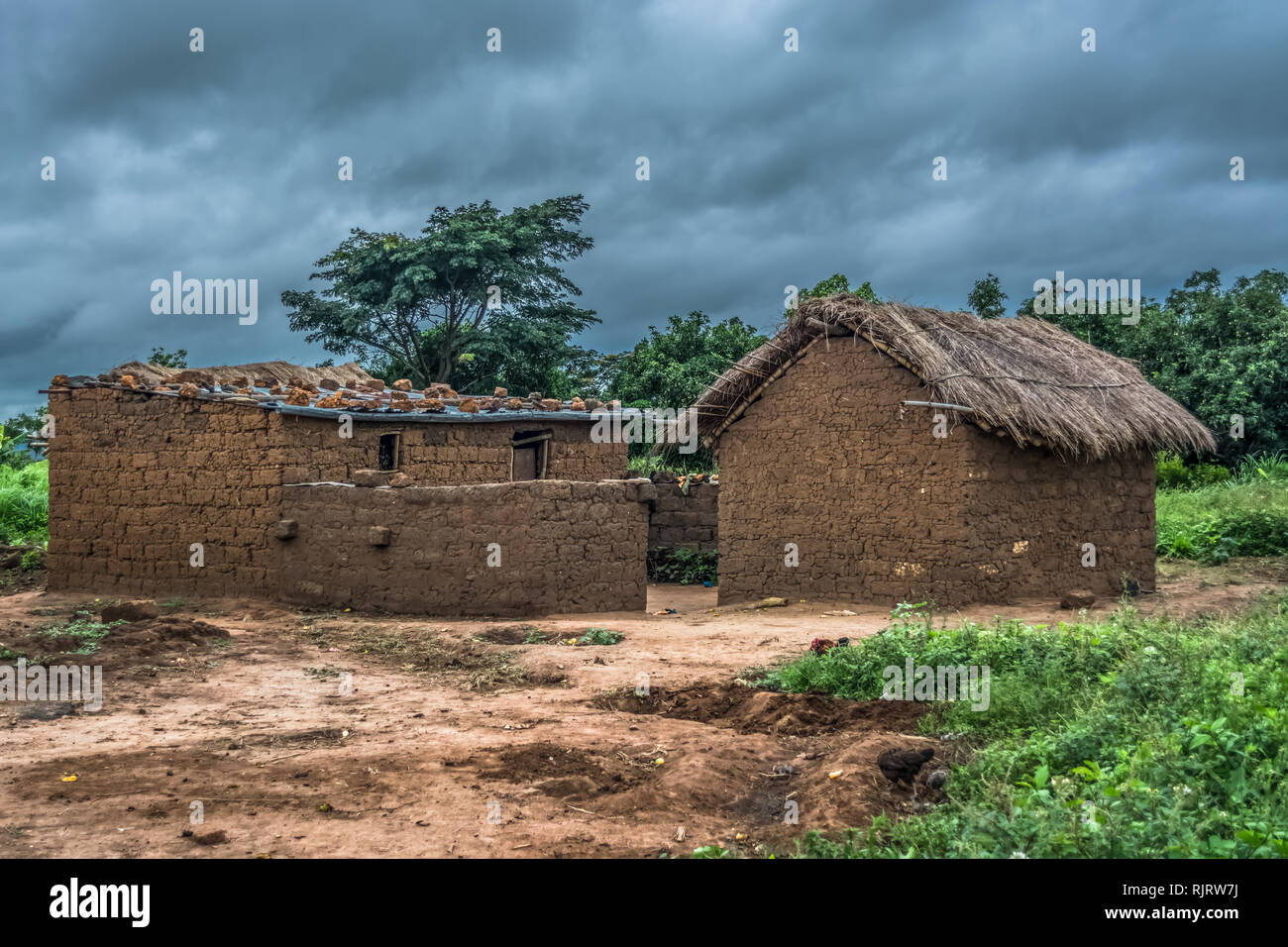 View of traditional village, house thatched on roof and terracotta ...