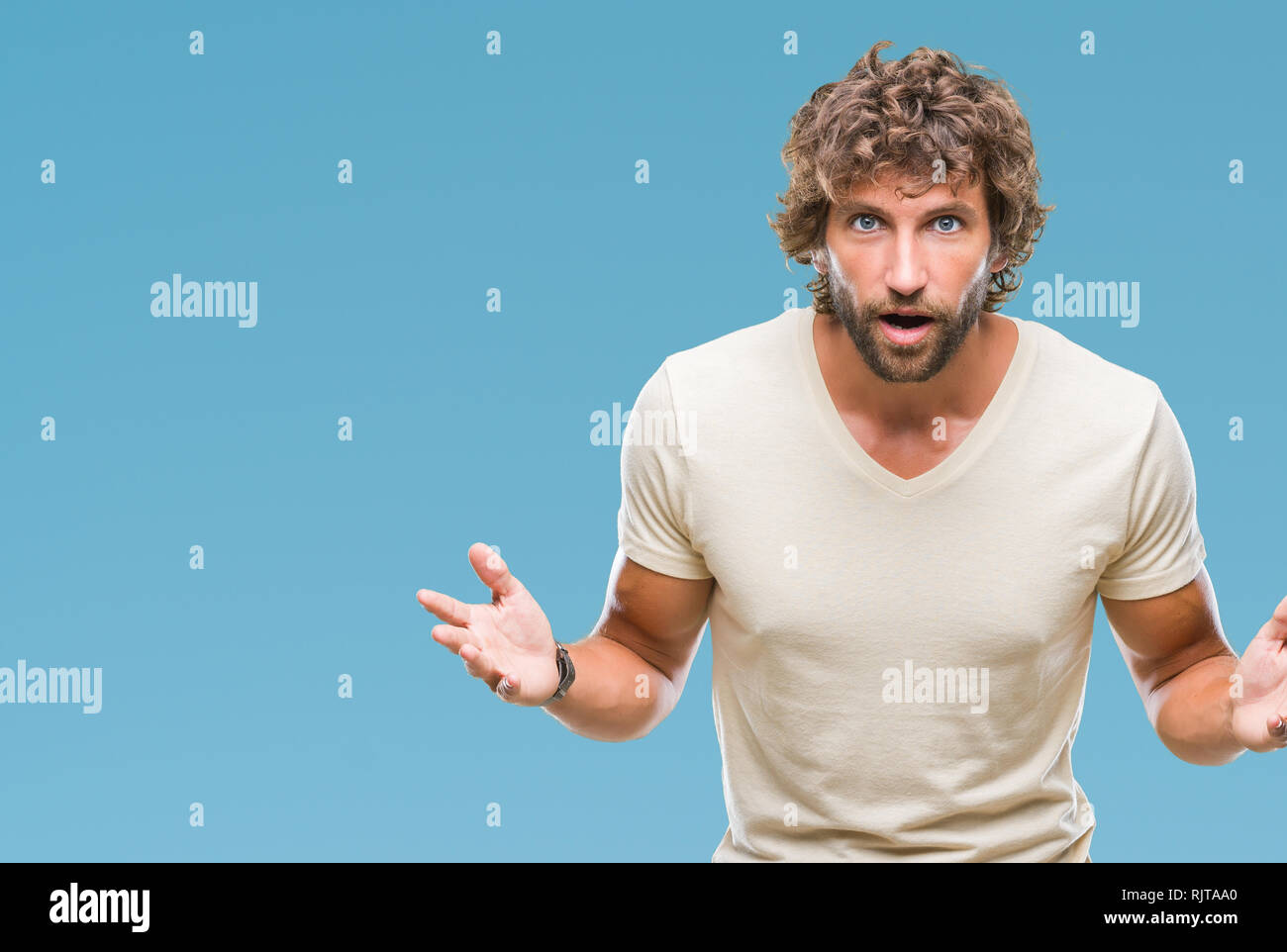 Handsome hispanic model man over isolated background afraid and shocked ...