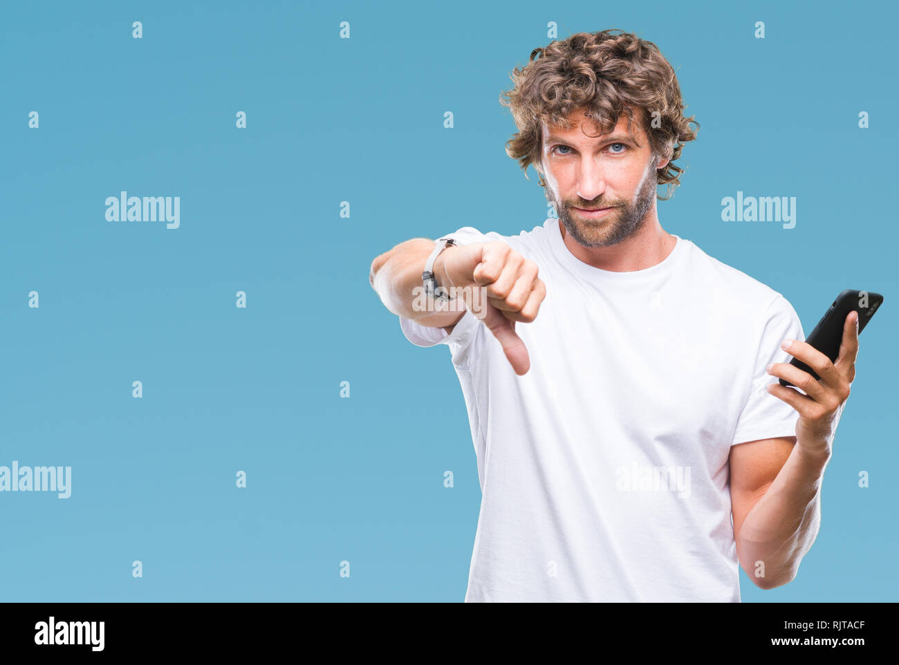 Handsome hispanic man model sending message texting using smartphone ...