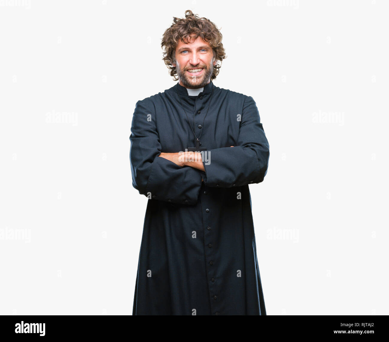 Handsome hispanic catholic priest man over isolated background happy ...
