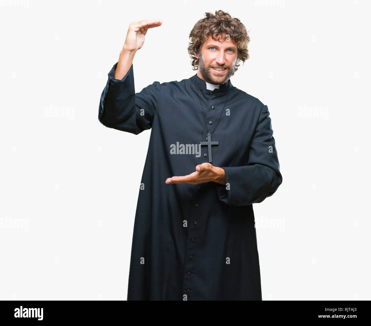 Handsome hispanic catholic priest man over isolated background ...