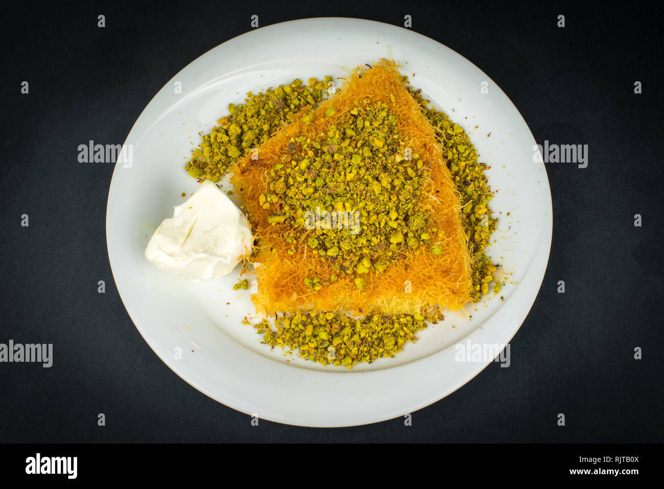 Traditional Turkish Dessert Kunefe isolated on black Stock Photo - Alamy
