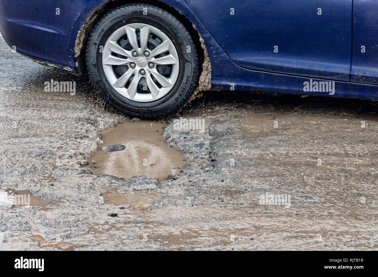Montreal, Canada - 7 February 2019: Car driving through a pothole Stock ...