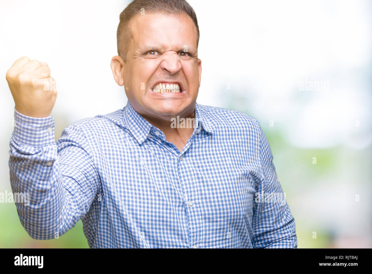 Middle age arab business man over isolated background angry and mad ...