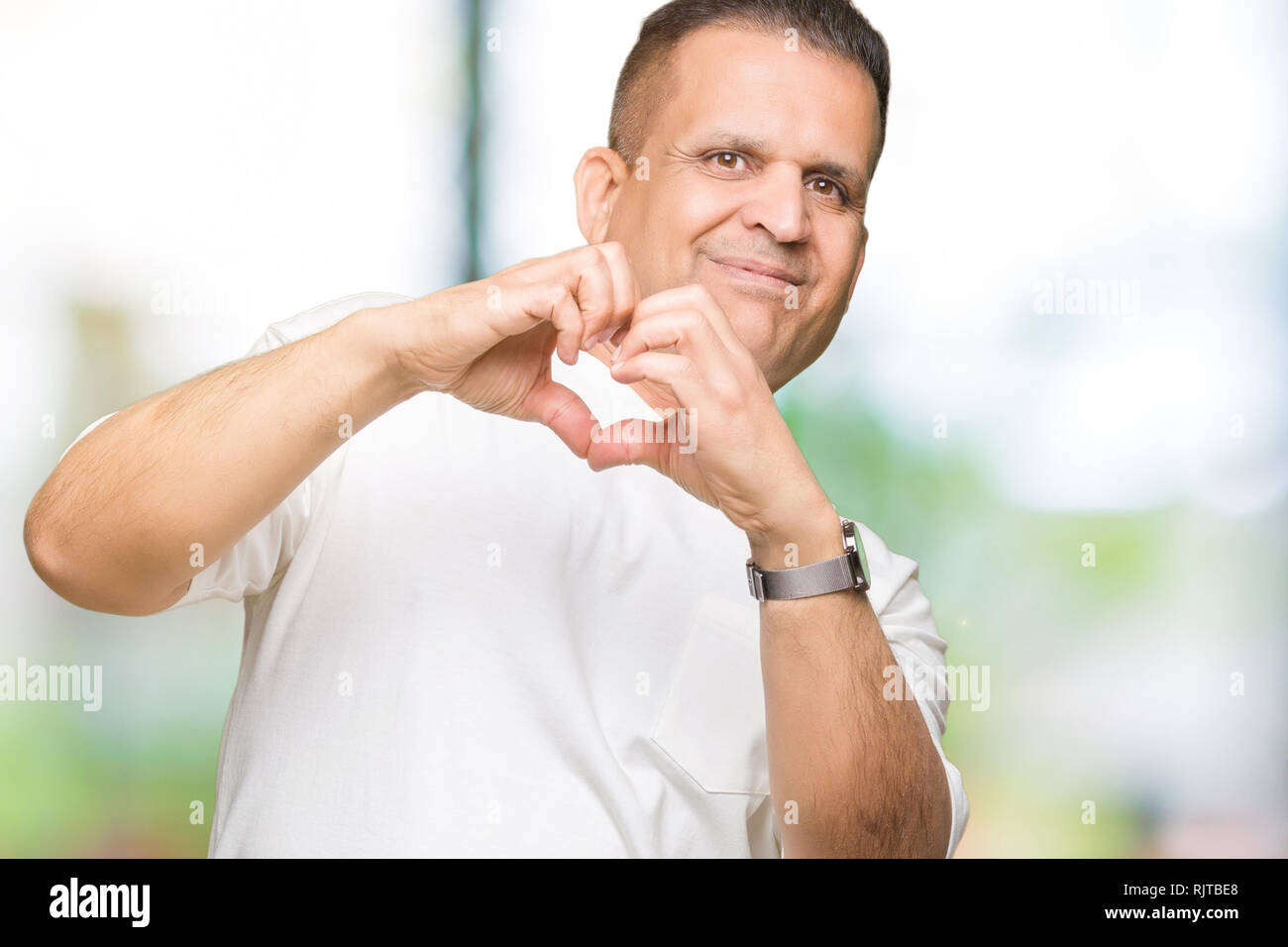 Middle age arab man wearig white t-shirt over isolated background ...