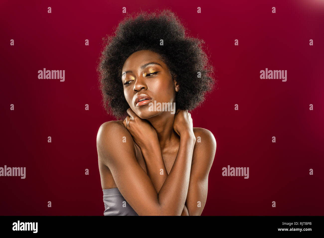 Nice pleasant woman standing against pink background Stock Photo - Alamy
