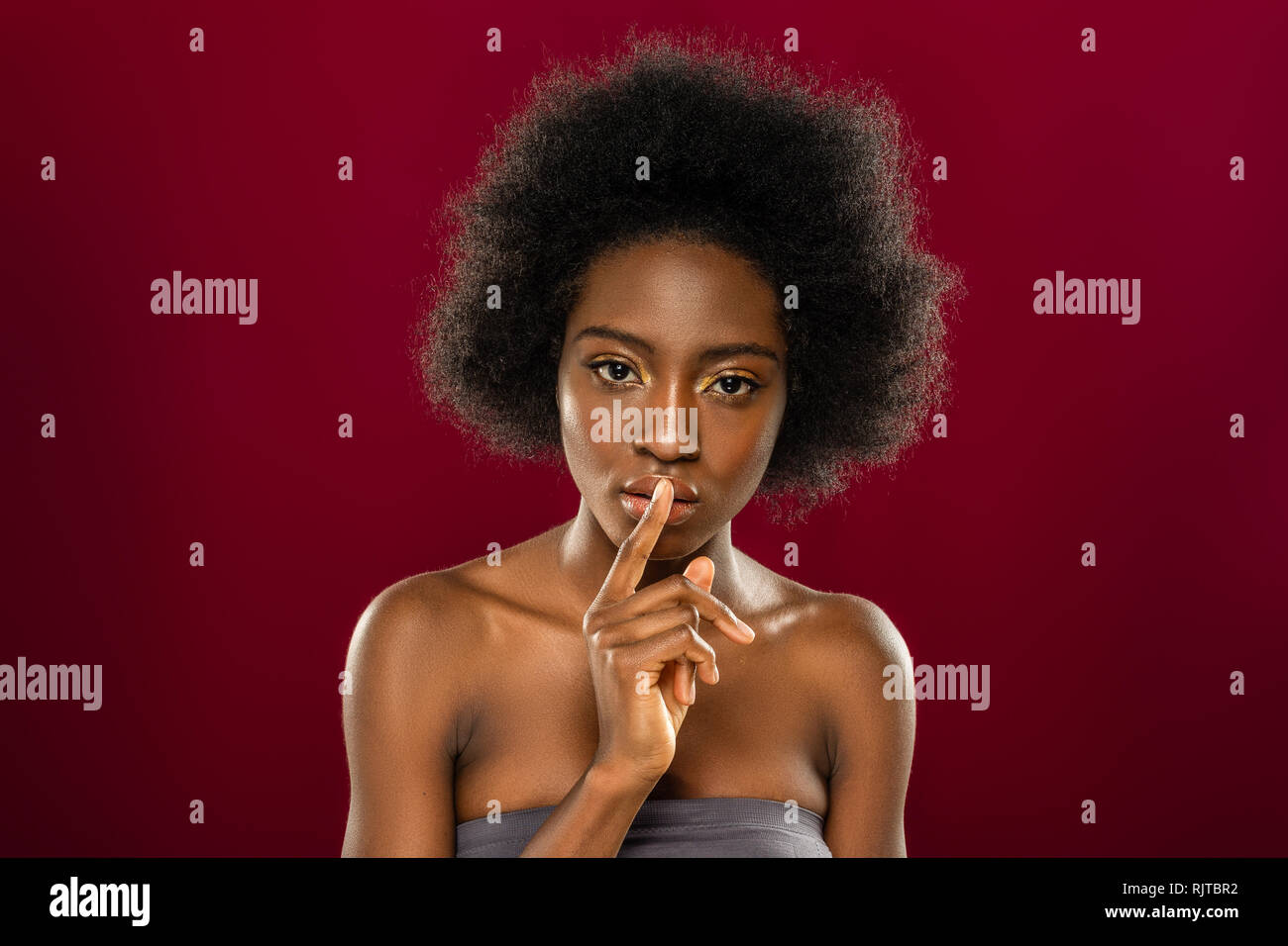 Woman putting finger lips hi-res stock photography and images - Alamy