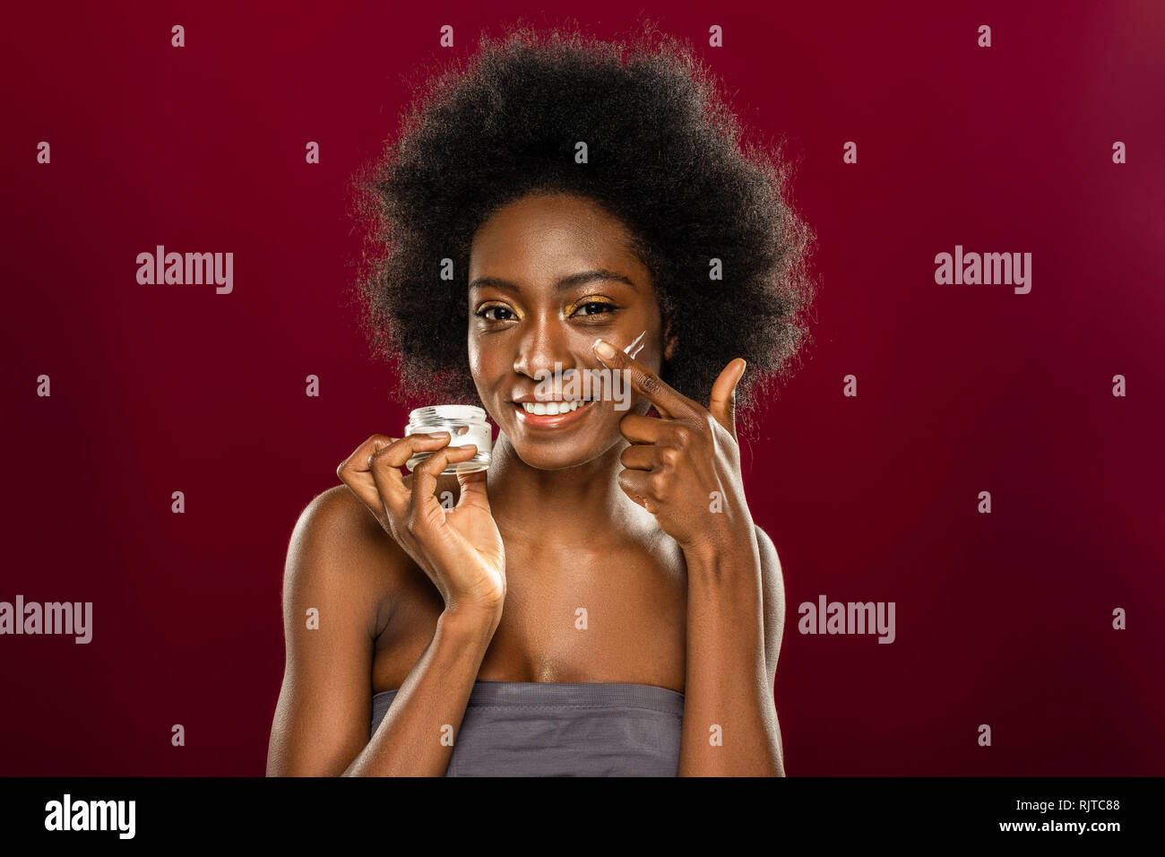 Woman applying cream on her face hi-res stock photography and images ...
