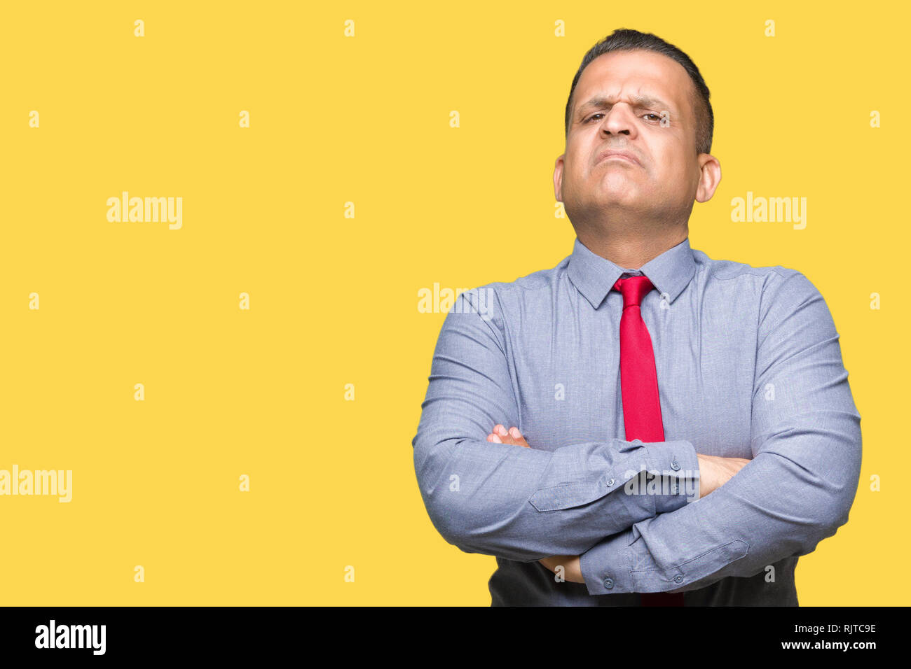 Middle age arab man wearing red tie over isolated background skeptic ...