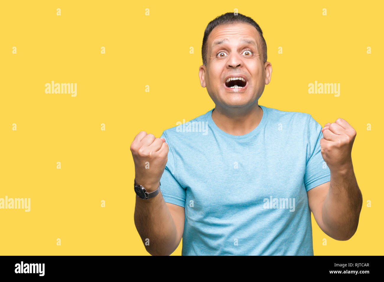 Middle age arab man wearing blue t-shirt over isolated background ...