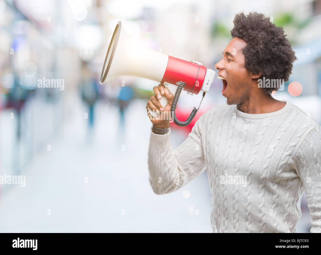 Young handsome afro american black man shouting through megaphone Stock ...