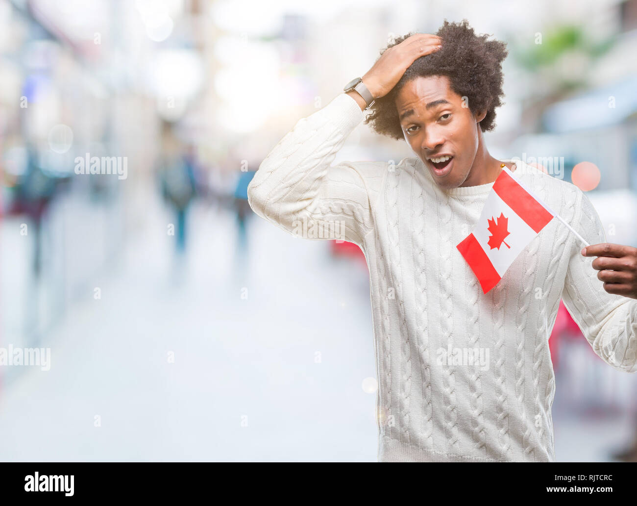 Afro american man flag of Canada over isolated background stressed with ...