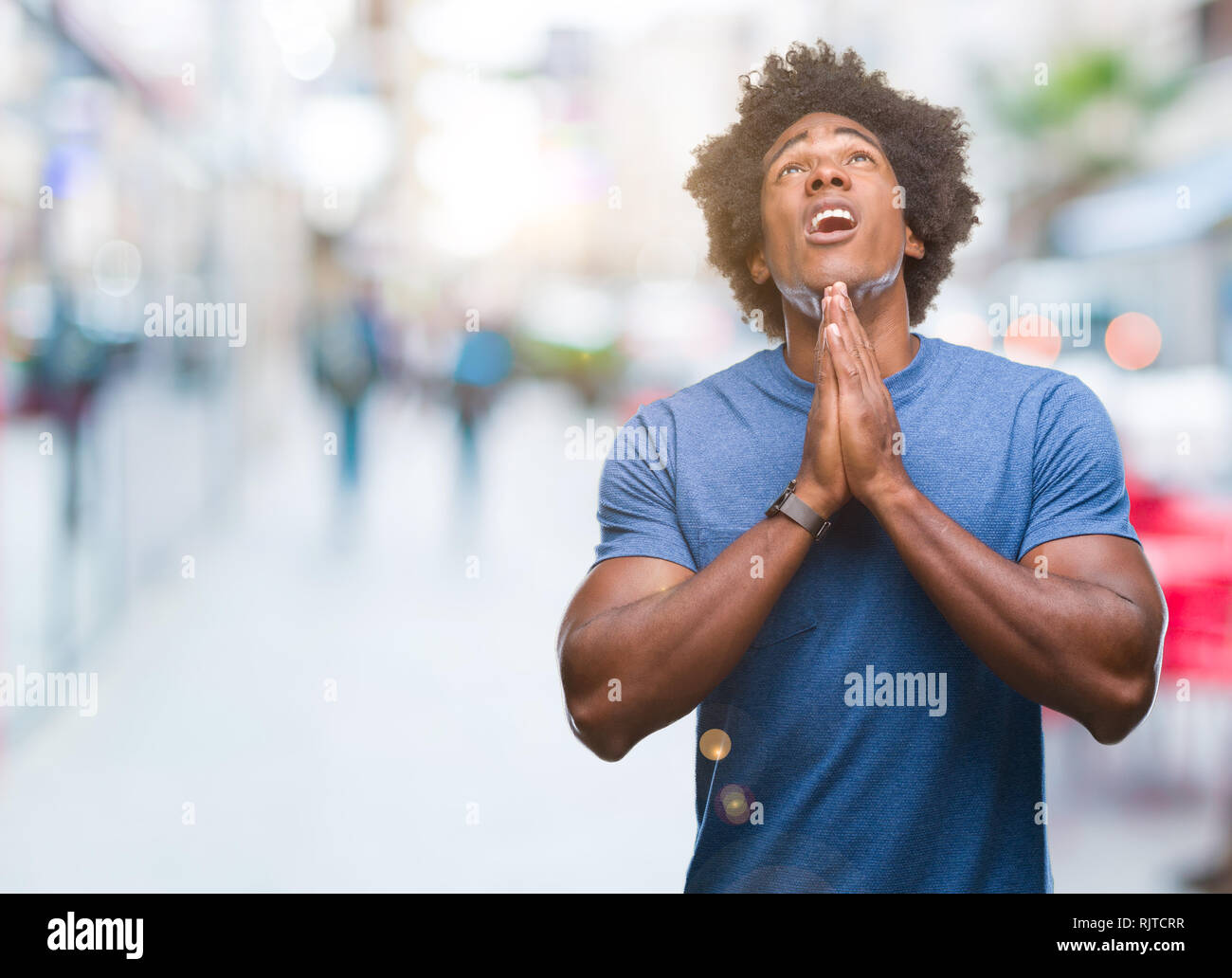 Afro american man over isolated background begging and praying with ...