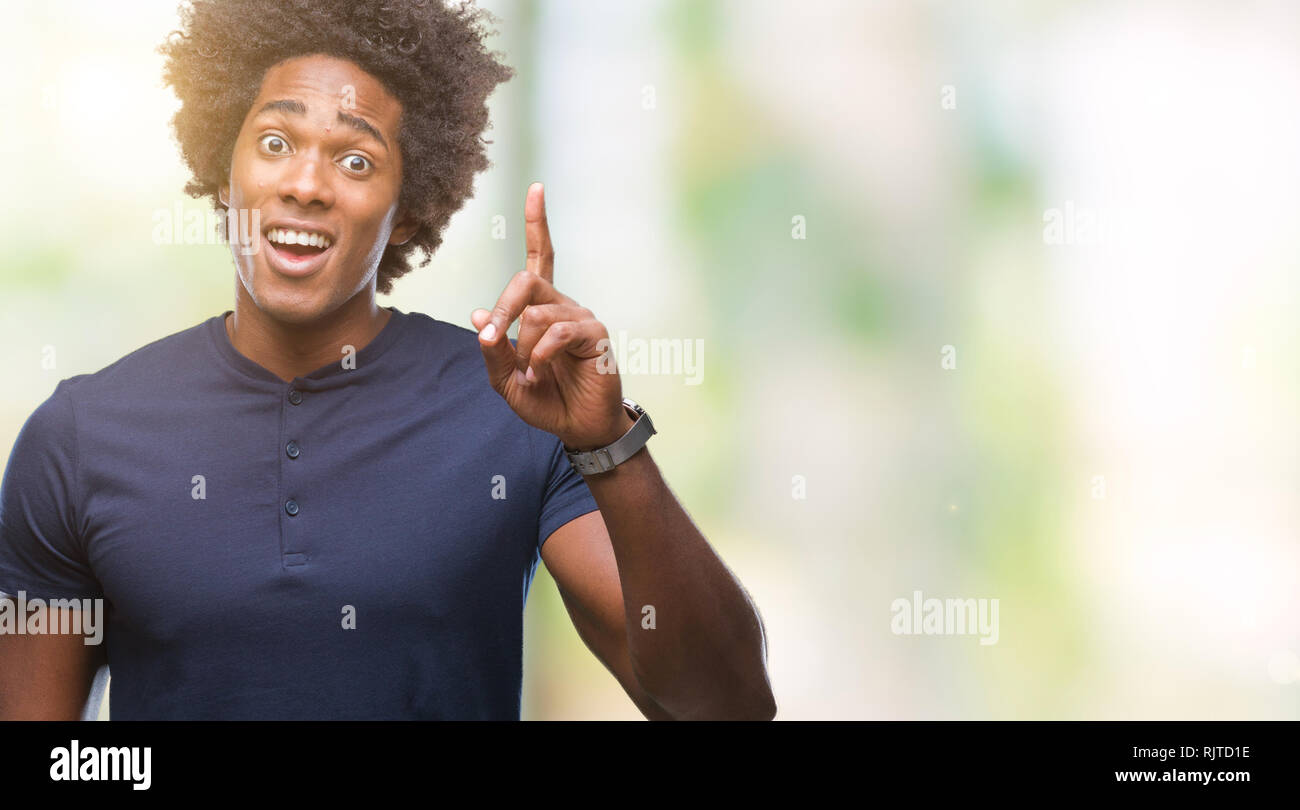 Afro american man over isolated background pointing finger up with ...