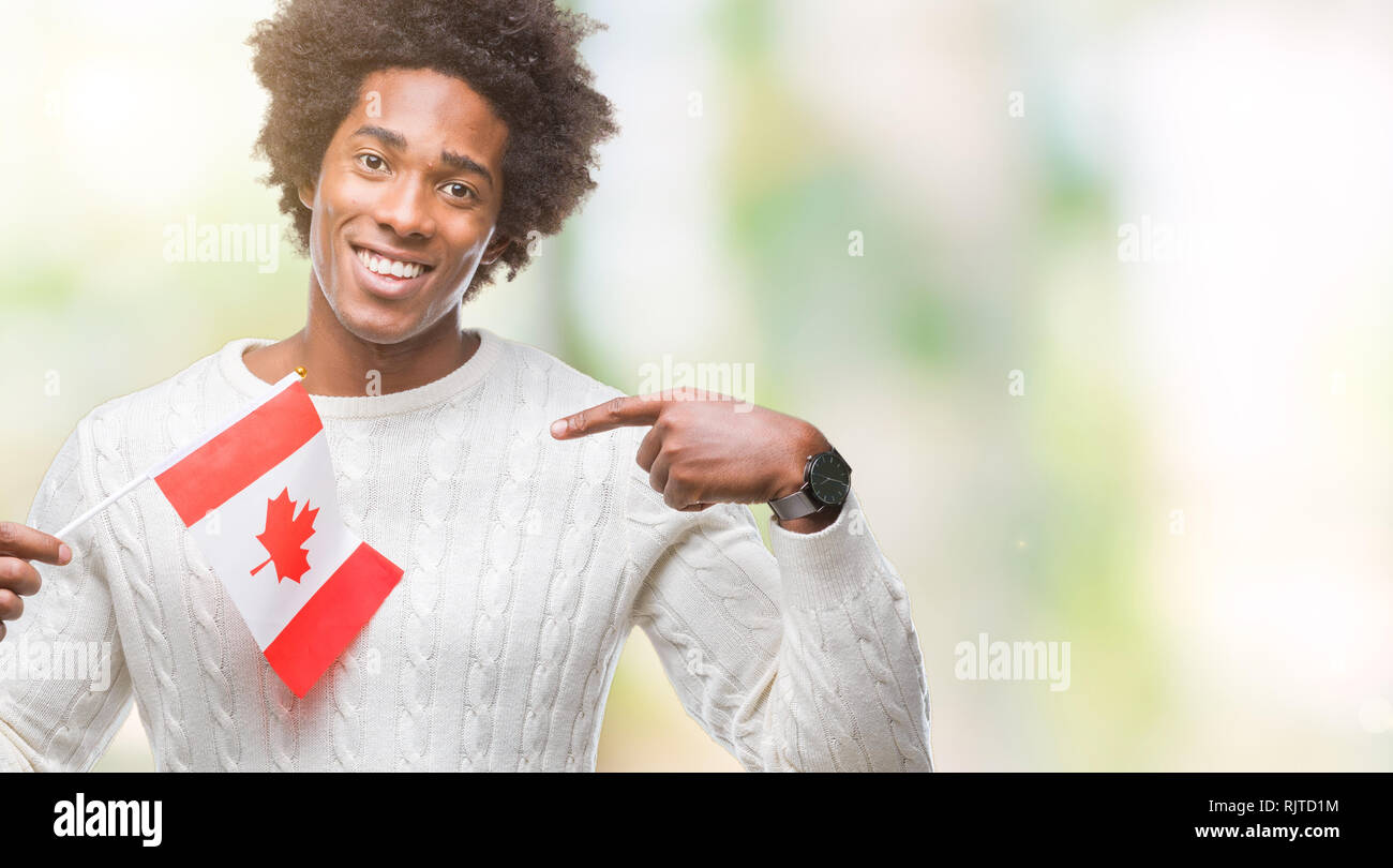 Afro american man flag of Canada over isolated background with surprise ...