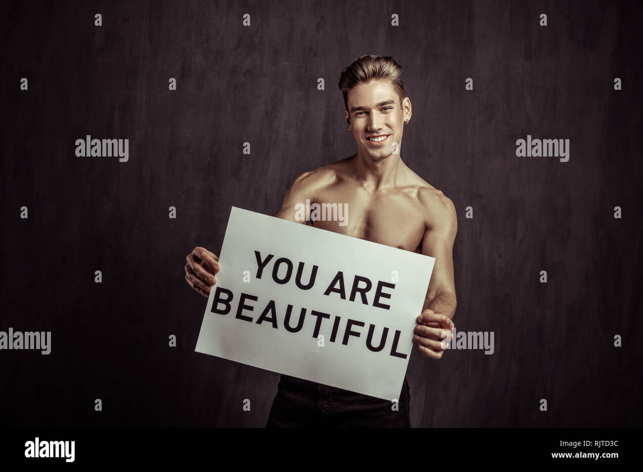 Positive handsome young man expressing his support Stock Photo - Alamy