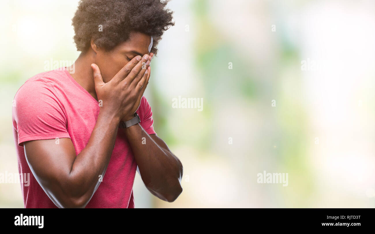 Afro american man over isolated background with sad expression covering ...